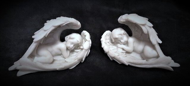 Baby Angels enfolded in wings